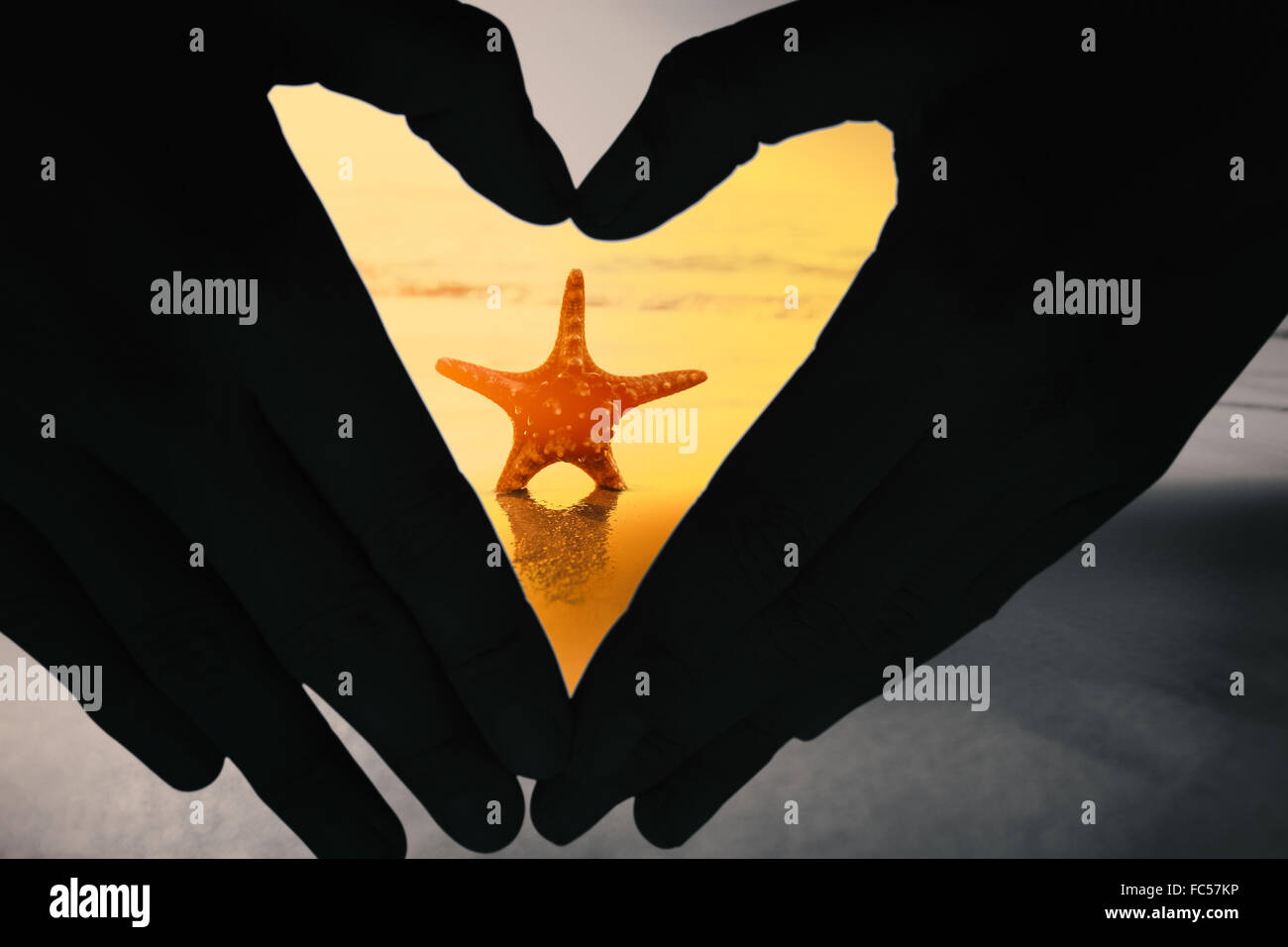 Composite image of woman making heart shape with hands Stock Photo - Alamy