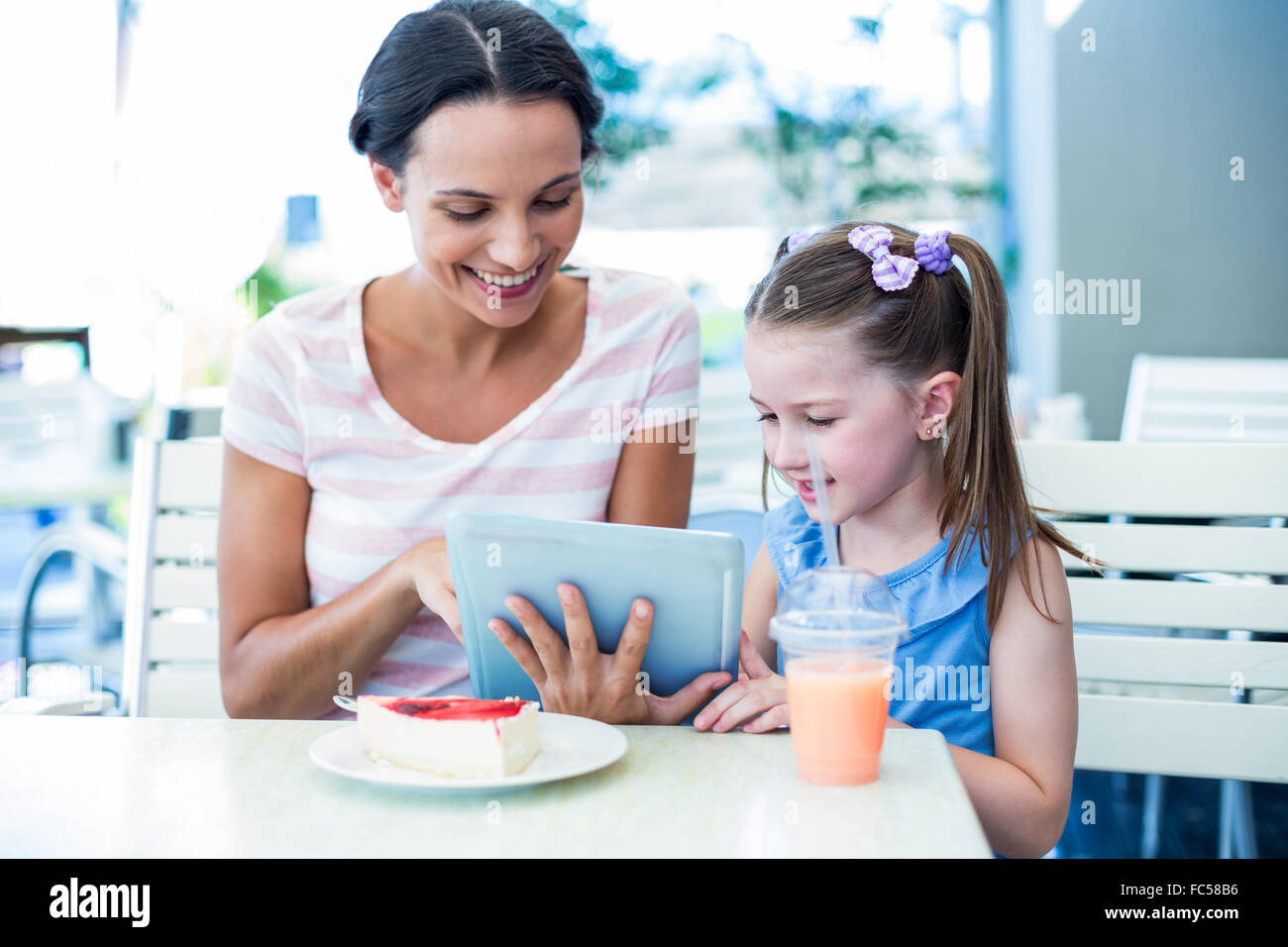 Mother and daughter using tablet computer together Stock Photo - Alamy