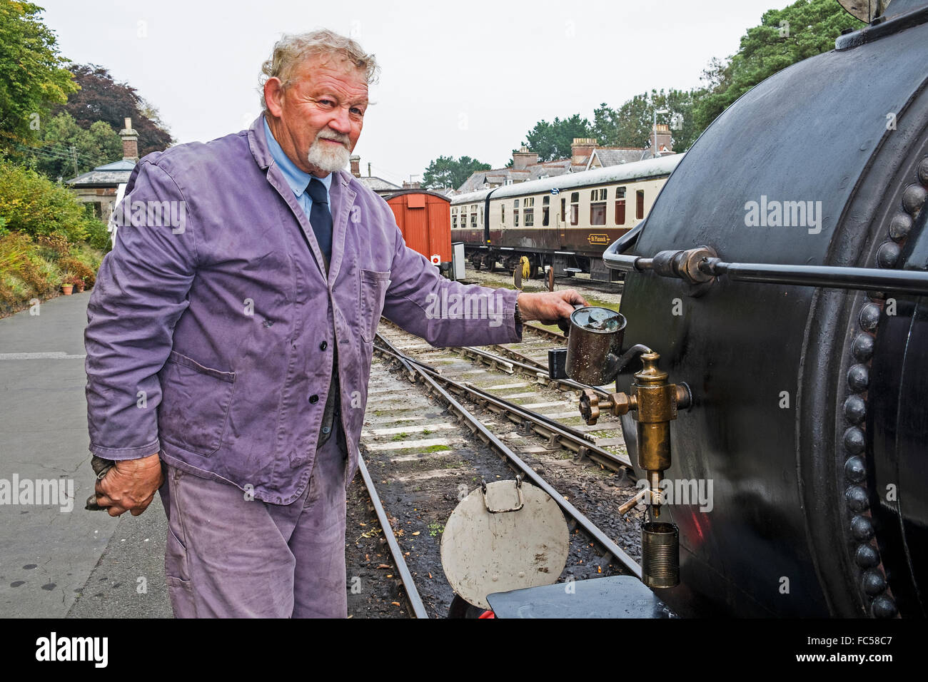 The engine driver checking the engine on the platform at the Bodmin ...