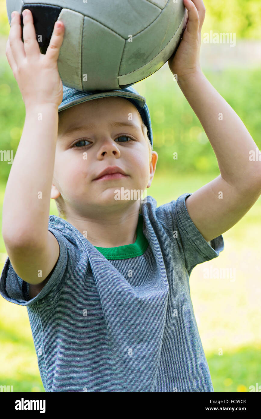 Little boy holding sport ball Stock Photo - Alamy