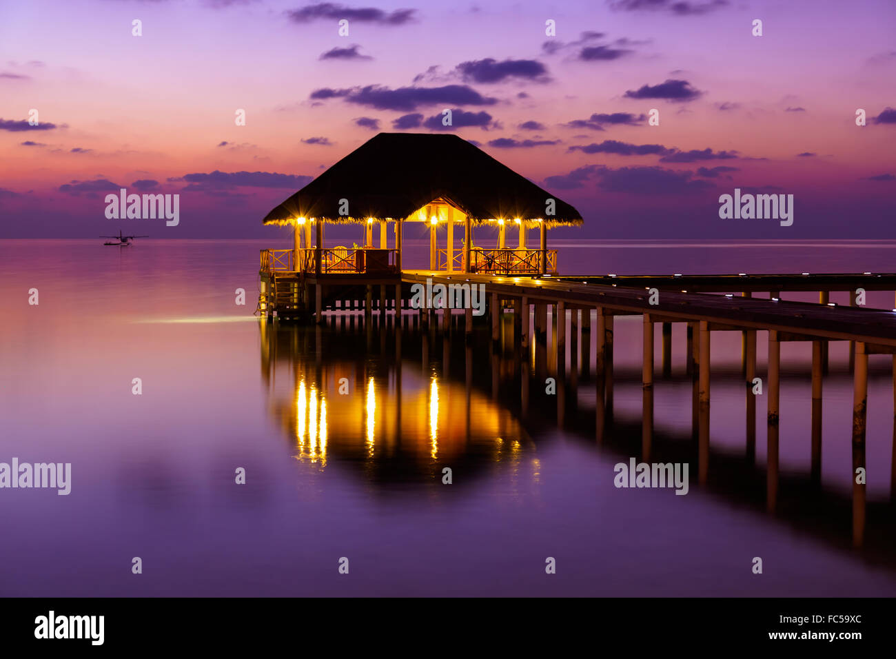 Water cafe at sunset - Maldives Stock Photo - Alamy