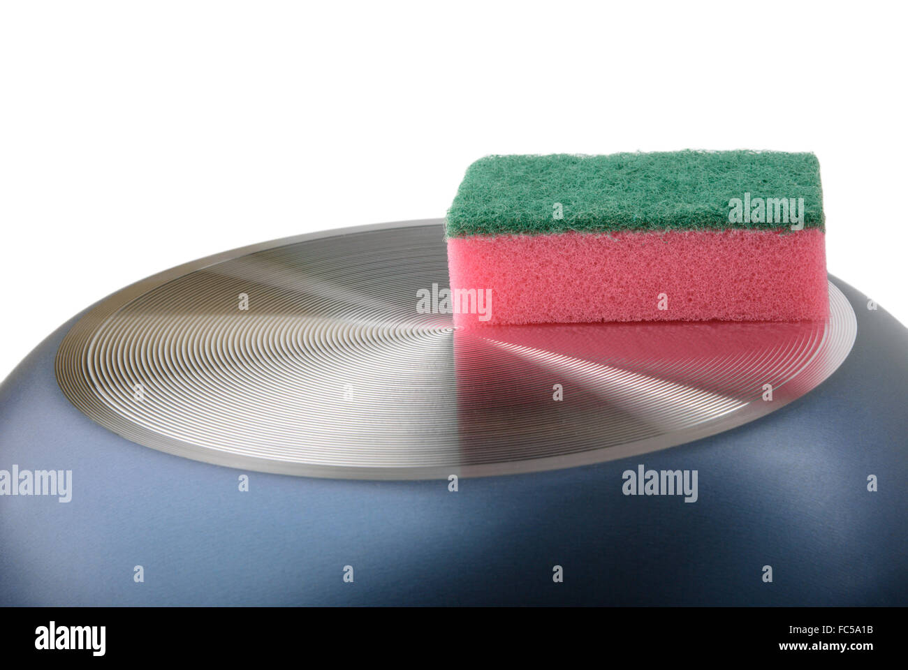 Sponge for ware lies on turned frying pan Stock Photo - Alamy