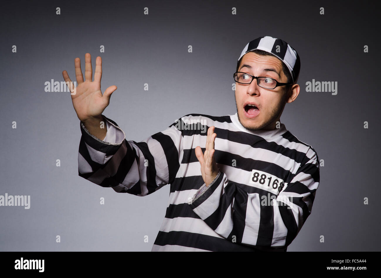 Funny prisoner isolated on gray Stock Photo - Alamy