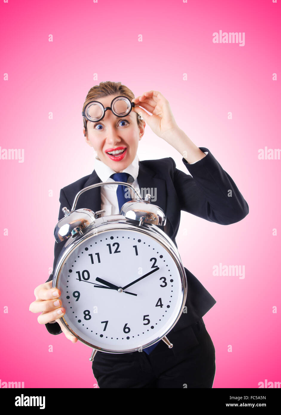 Nerd businesswoman with giant alarm clock Stock Photo - Alamy