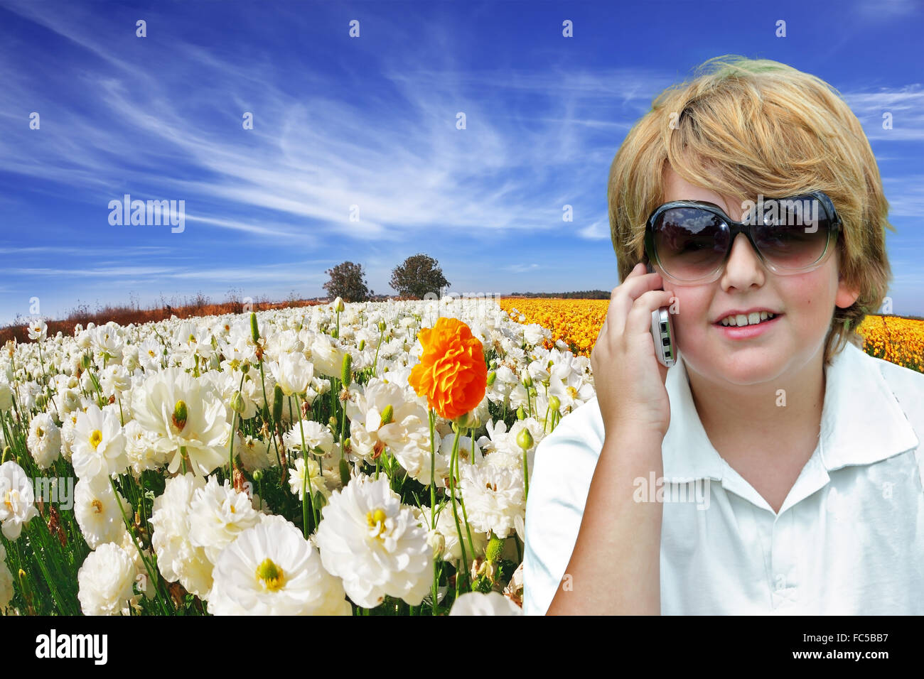 Thel blond boy talking on his mobile phone Stock Photo - Alamy