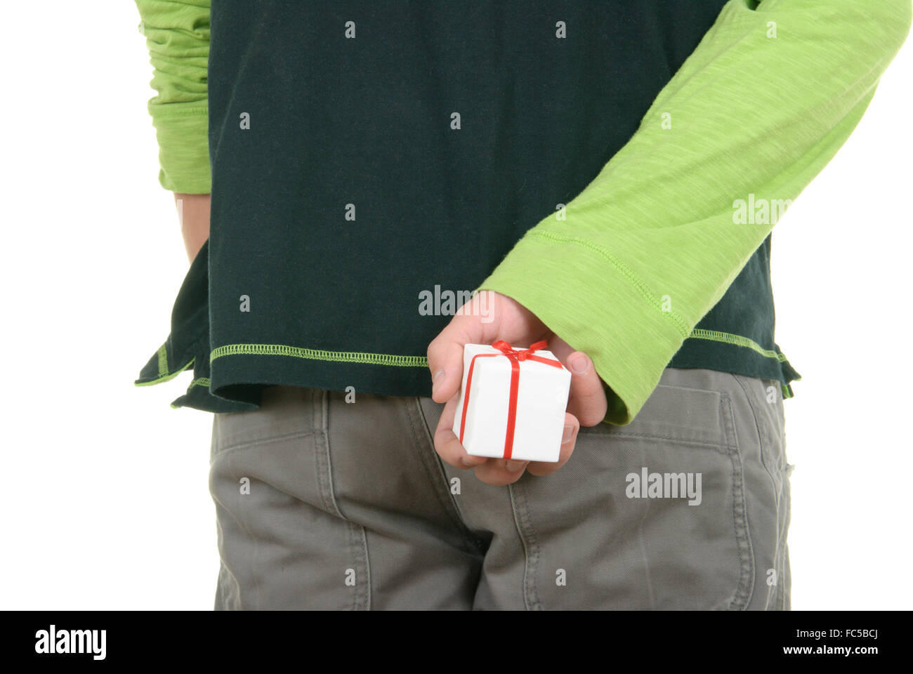 Hand hides small gift behind back Stock Photo - Alamy