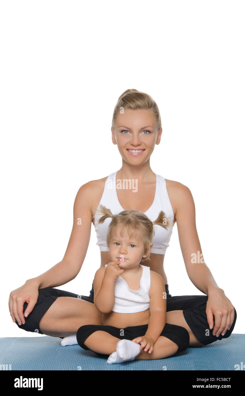 Mom and daughter doing yoga on mat Stock Photo - Alamy