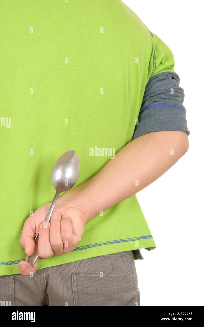 Teenager hides spoon Stock Photo - Alamy