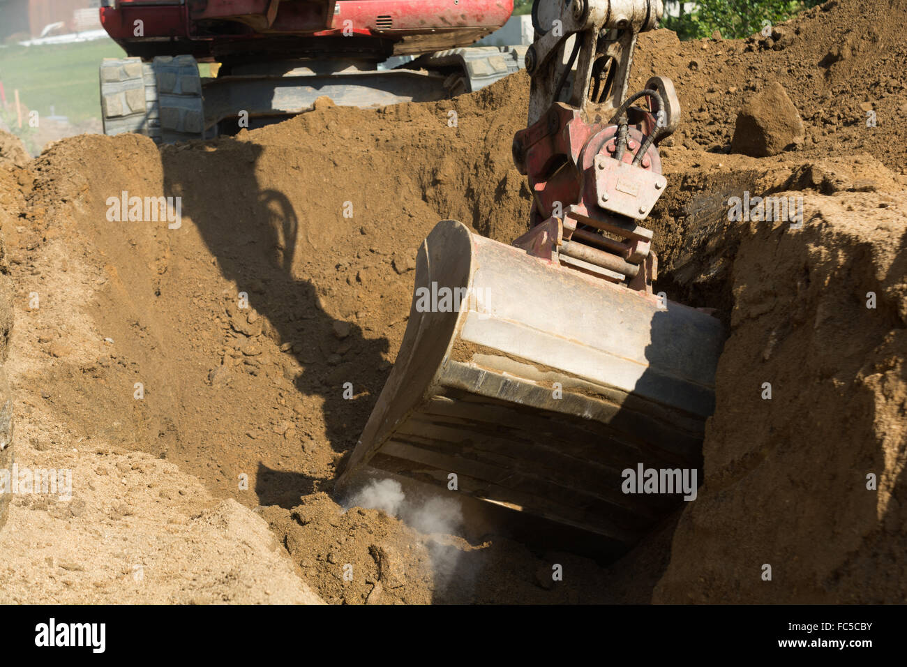 Excavators encounters hard ground Stock Photo - Alamy