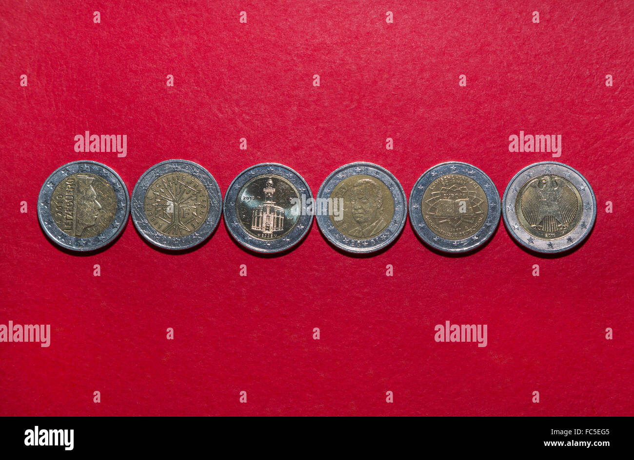 metal coins. red background Stock Photo - Alamy