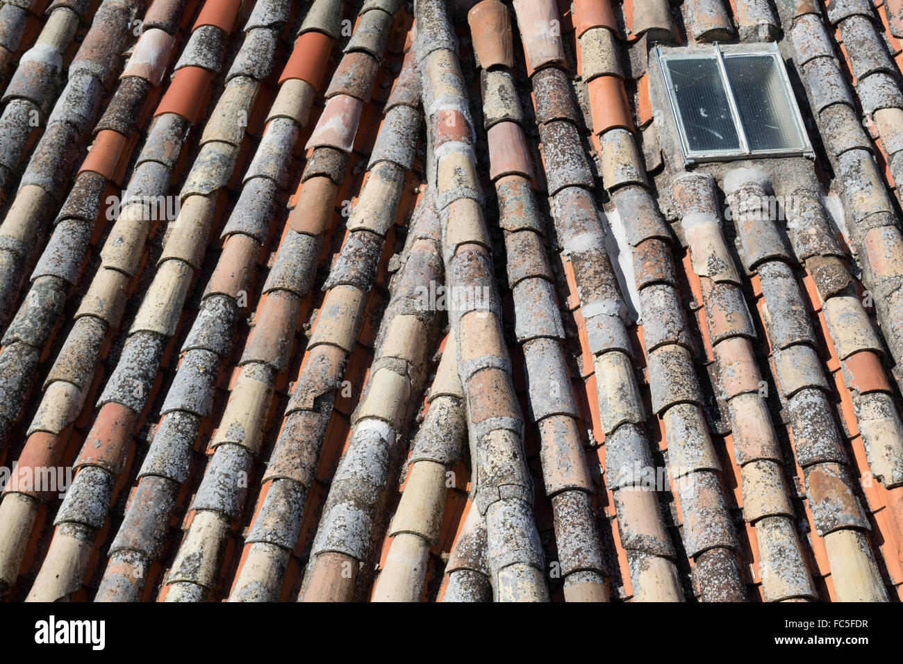 Roof tiles around a window Stock Photo - Alamy