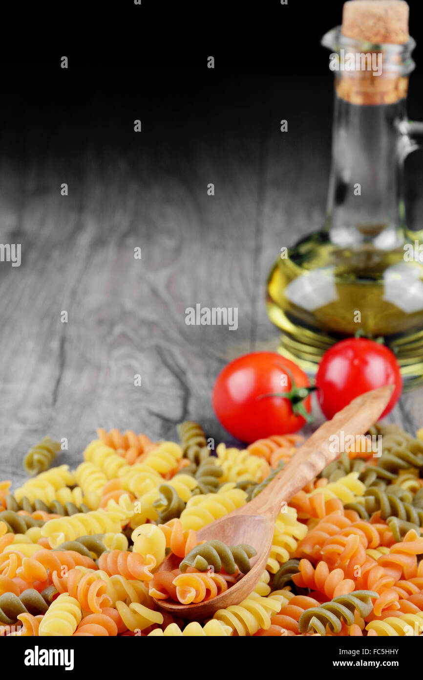 Raw eliche tricolori pasta background Stock Photo - Alamy