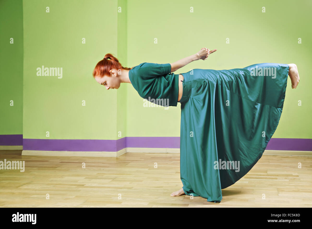 Redhead dancer in green dress Stock Photo - Alamy