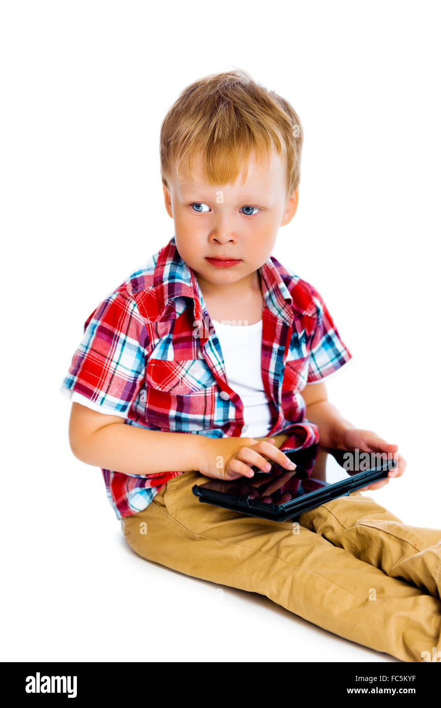 boy with a Tablet PC sitting on the floor Stock Photo - Alamy
