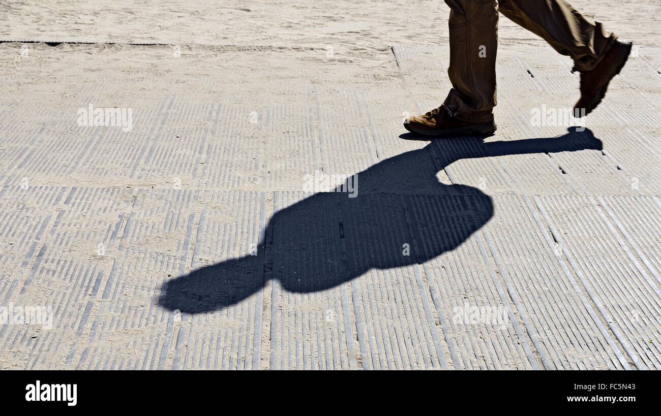 shadow of a walker on a sandy beach way Stock Photo - Alamy