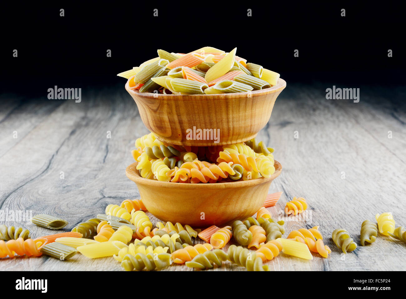 Raw eliche tricolori pasta background Stock Photo - Alamy