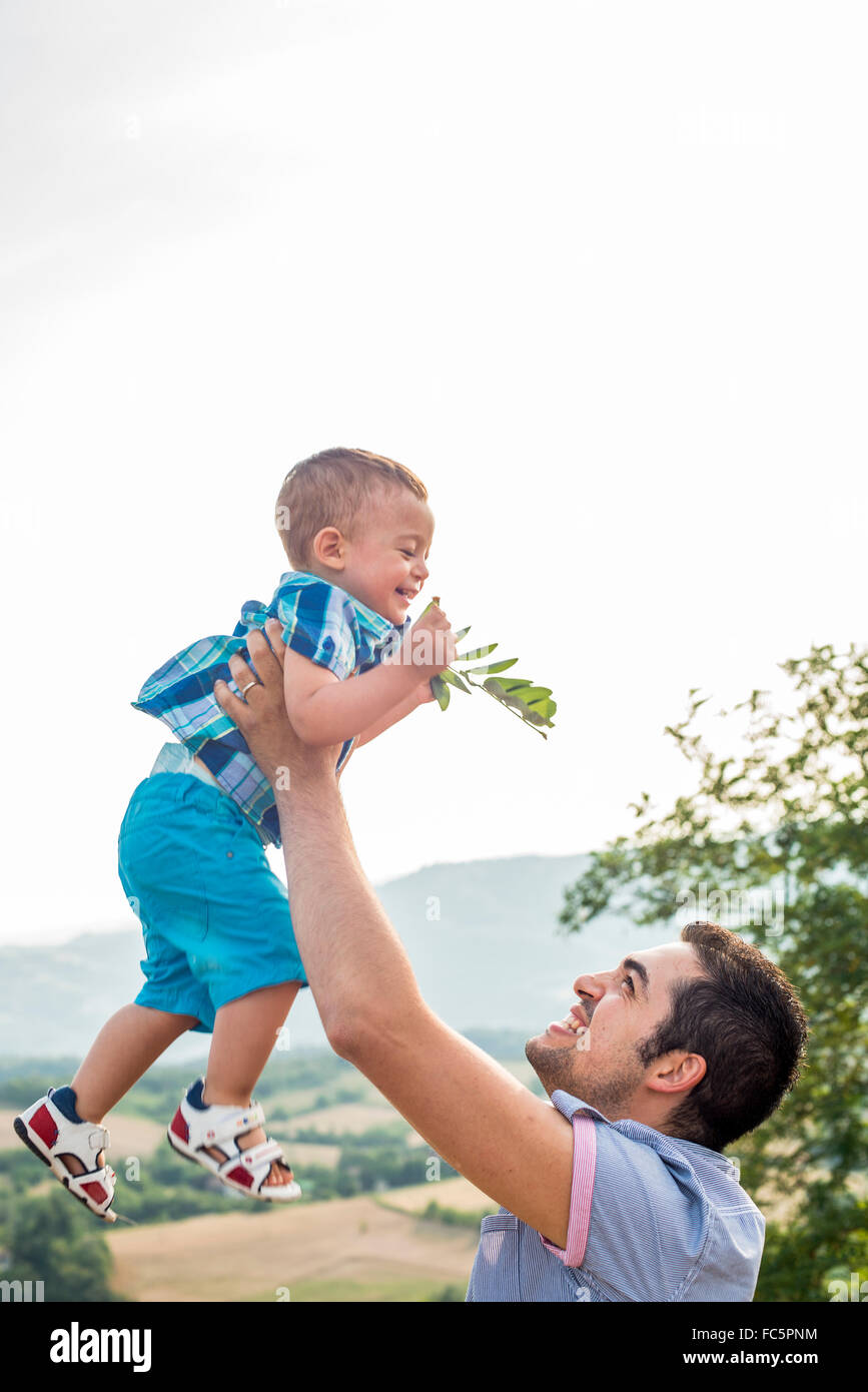 Father Lifting Son in Air Stock Photo - Alamy