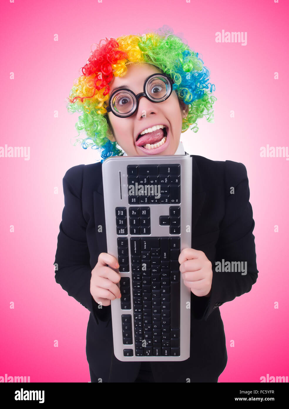 Funny clown with keyboard on white Stock Photo - Alamy