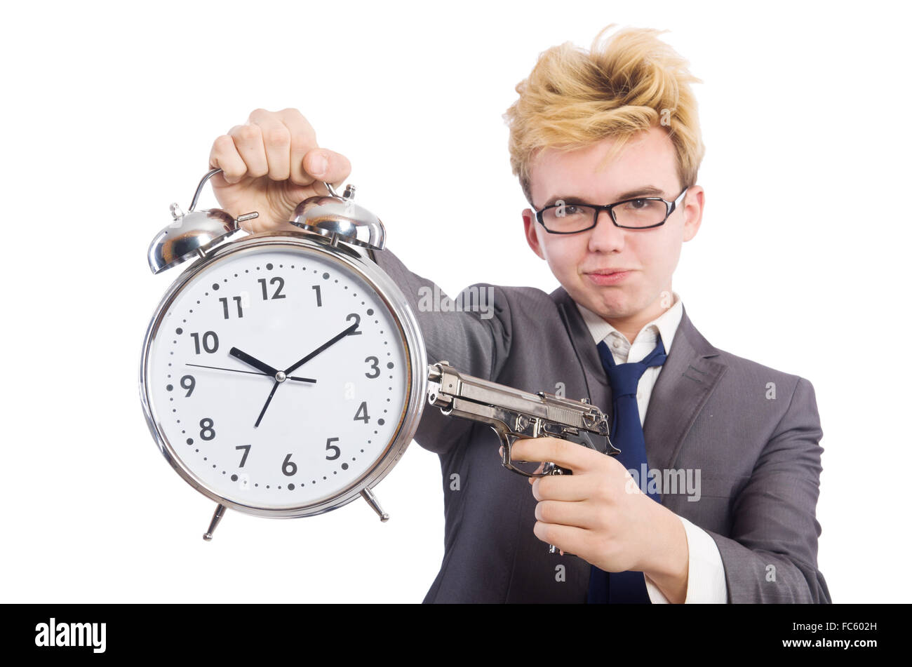 Young businessman holidng gun and alarm clock isolated on white Stock ...