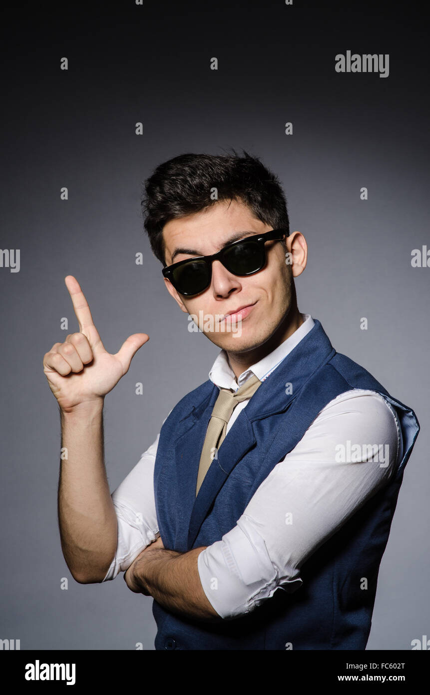 Young man in blue vest against gray Stock Photo - Alamy