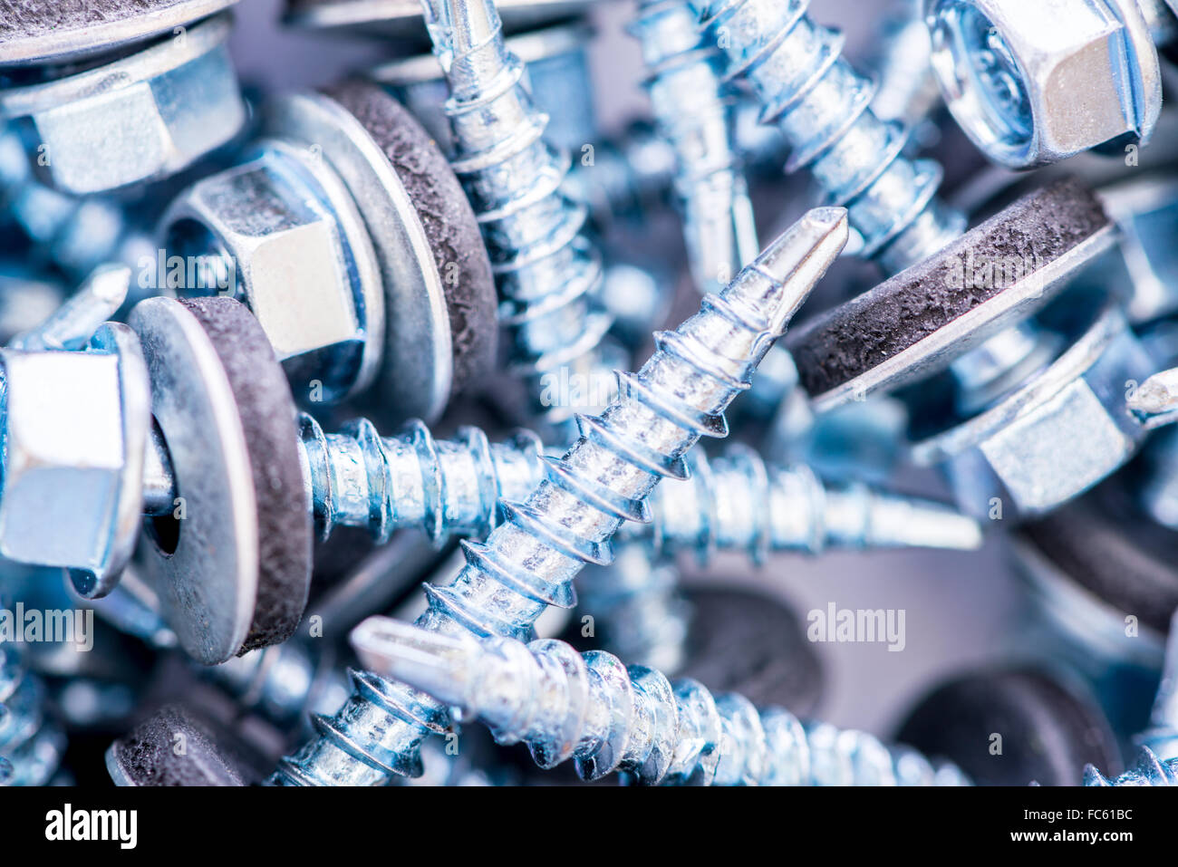 Many screws arranged as background Stock Photo - Alamy