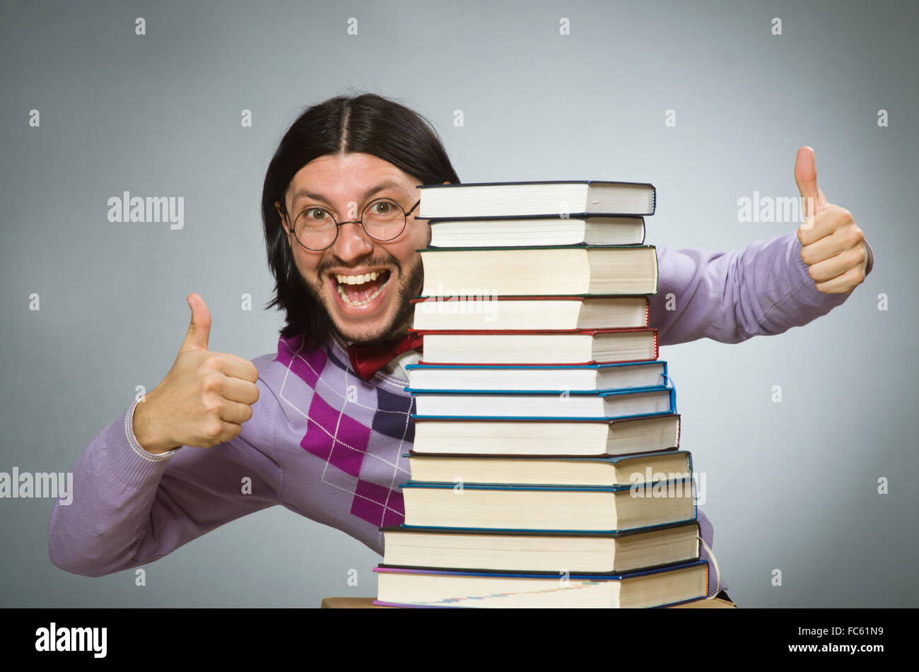 Young student with book in learning concept Stock Photo - Alamy