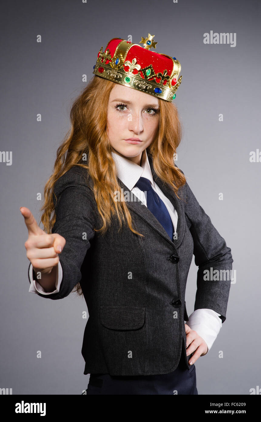 Businesslady wearing crown against gray Stock Photo - Alamy