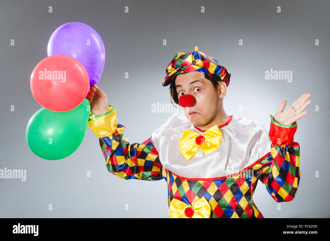 Clown with balloons in funny concept Stock Photo - Alamy