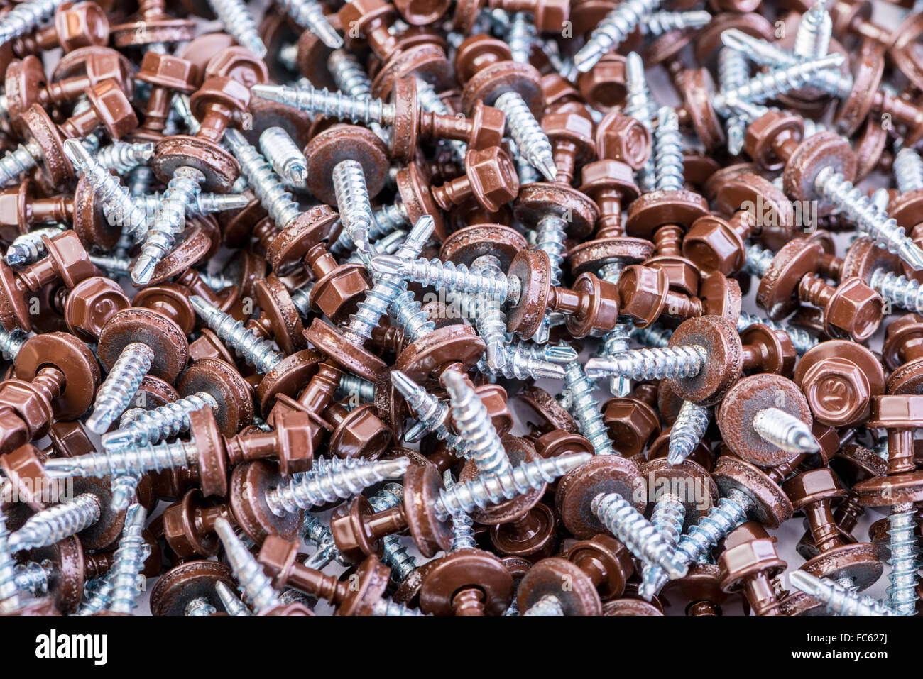 Many screws arranged as background Stock Photo - Alamy
