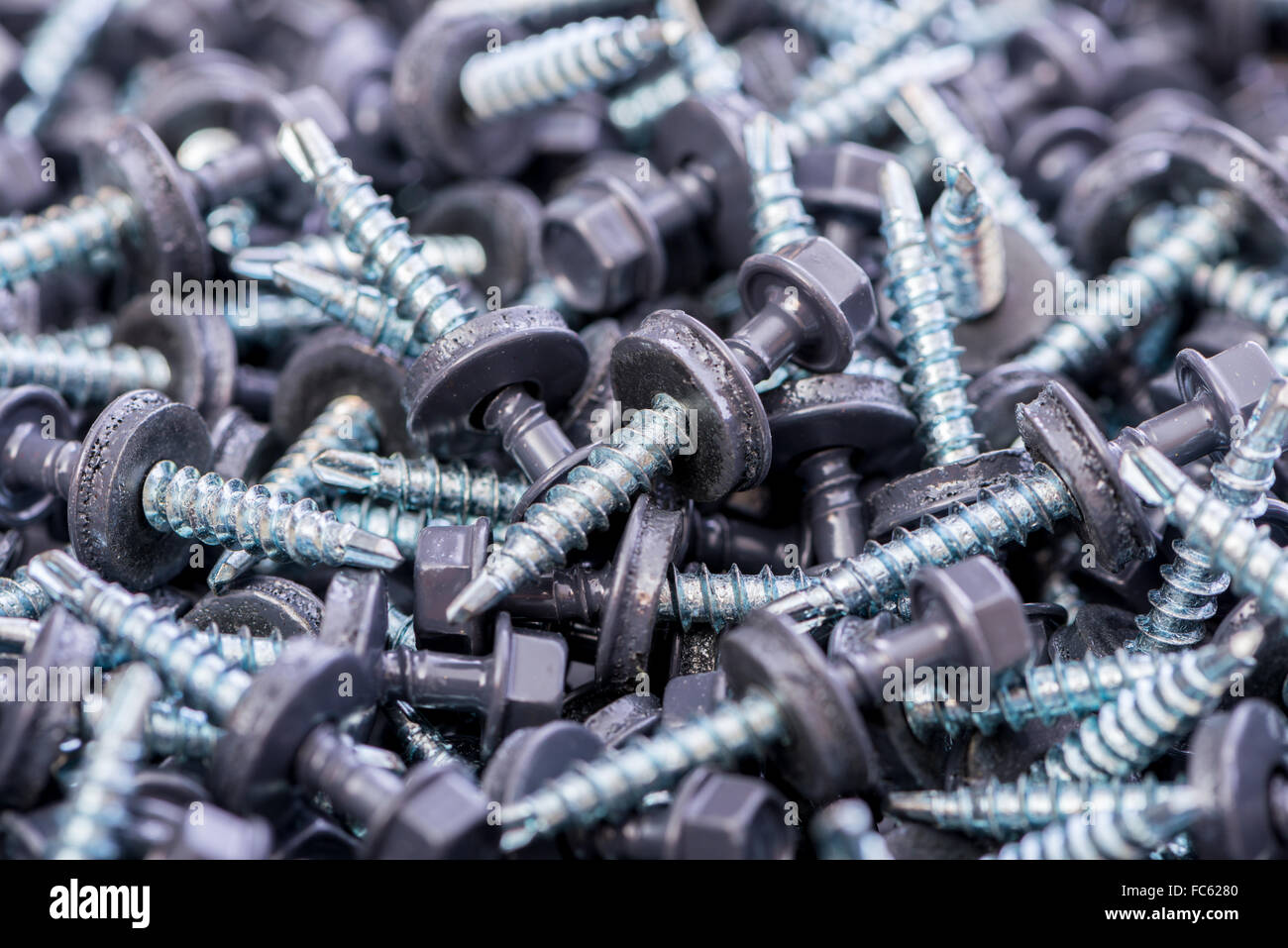 Many screws arranged as background Stock Photo - Alamy