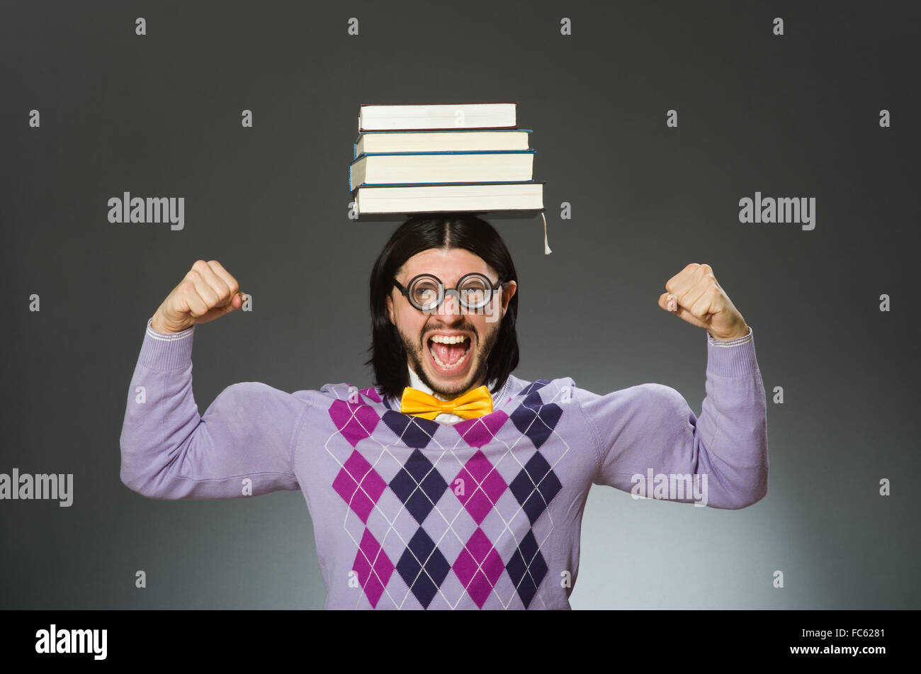 Young student with book in learning concept Stock Photo - Alamy