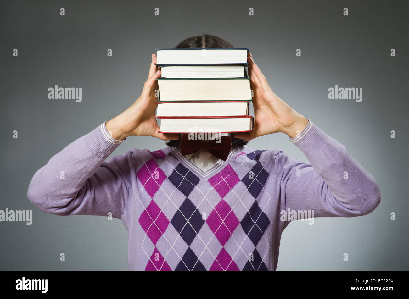 Young student with book in learning concept Stock Photo - Alamy