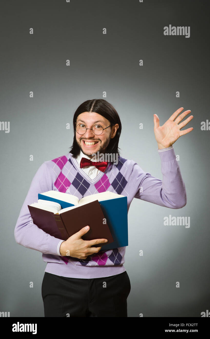 Young student with book in learning concept Stock Photo - Alamy