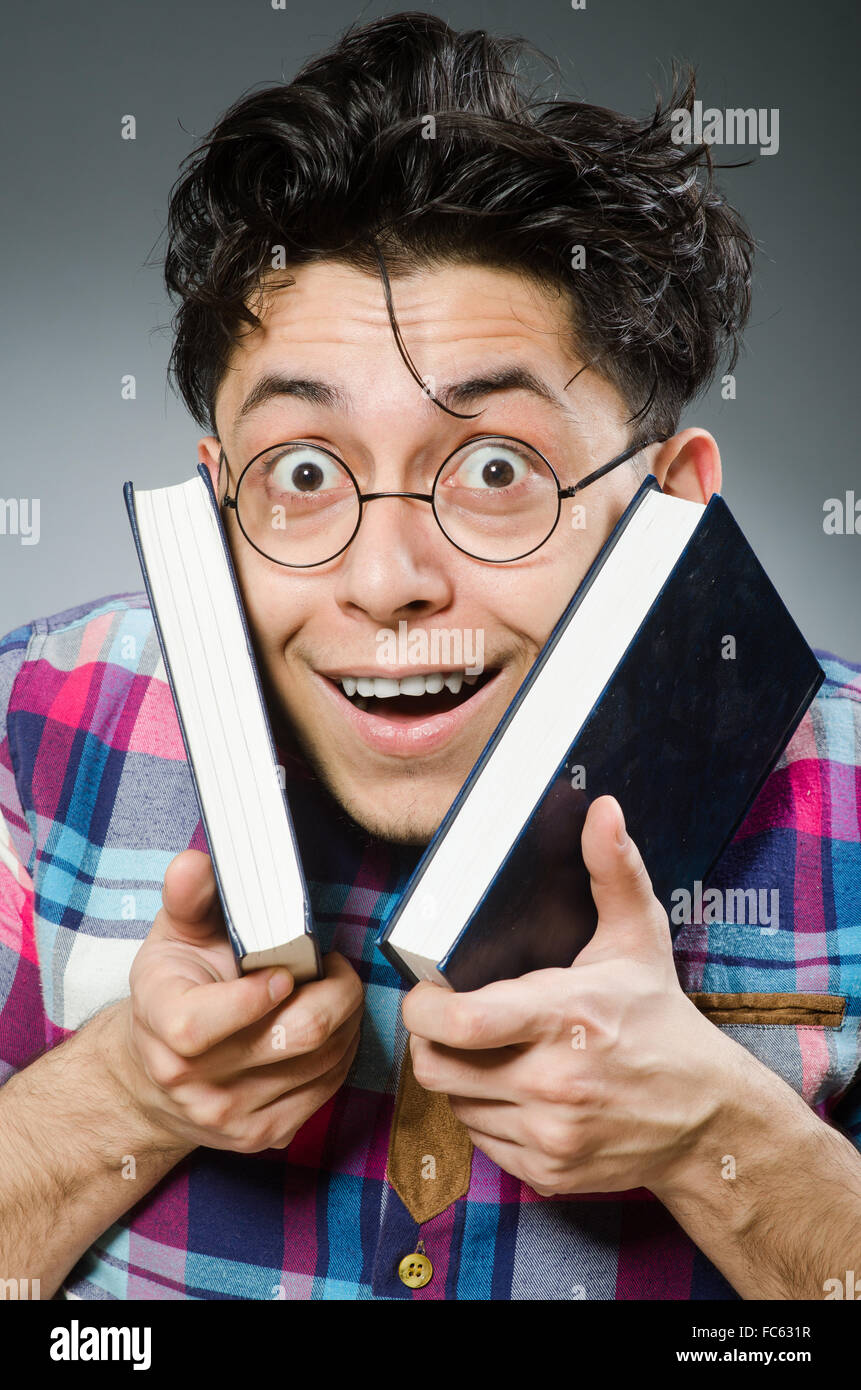 Funny student with many books Stock Photo - Alamy