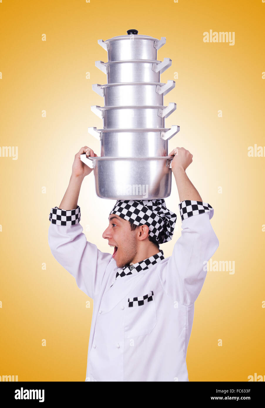 Cook with stack of pots on white Stock Photo - Alamy