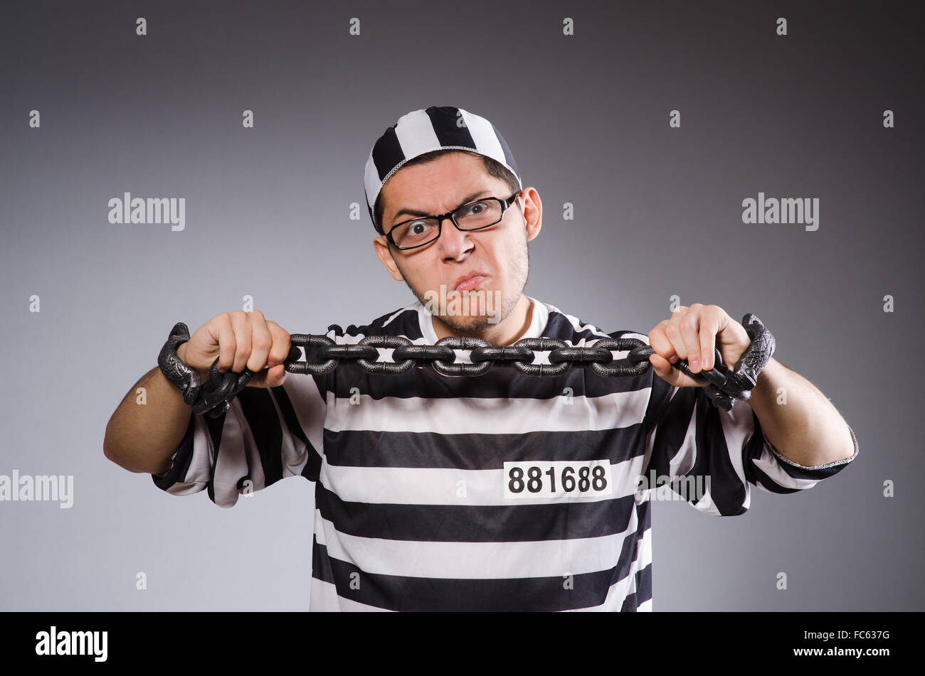 Young prisoner against gray Stock Photo - Alamy