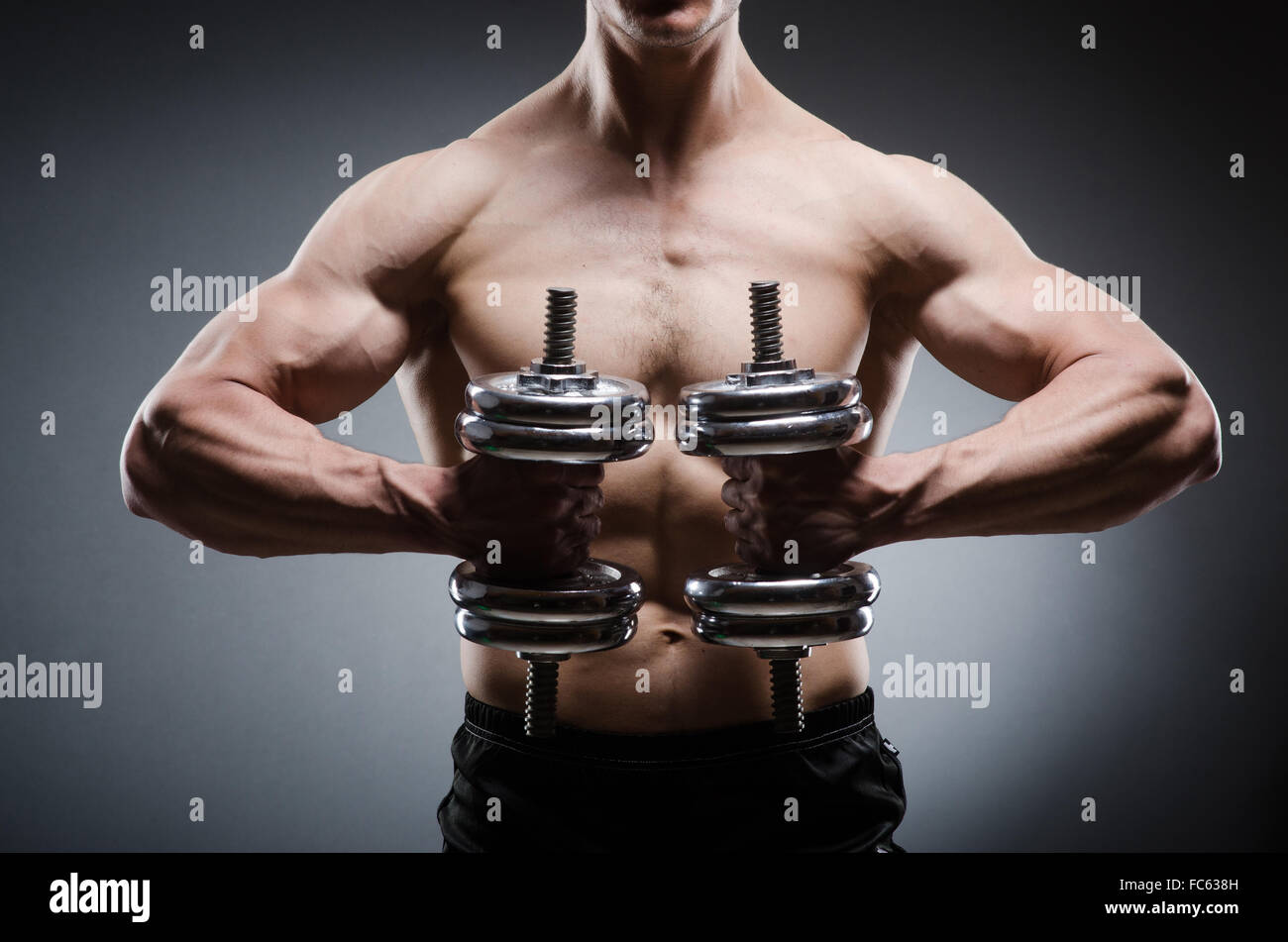 Muscular ripped bodybuilder with dumbbells Stock Photo - Alamy