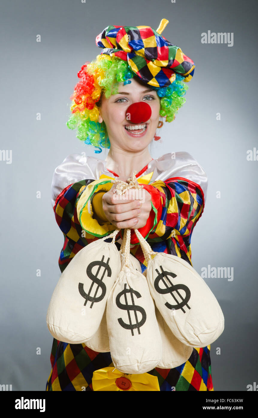 Clown with money bag in funny concept Stock Photo - Alamy