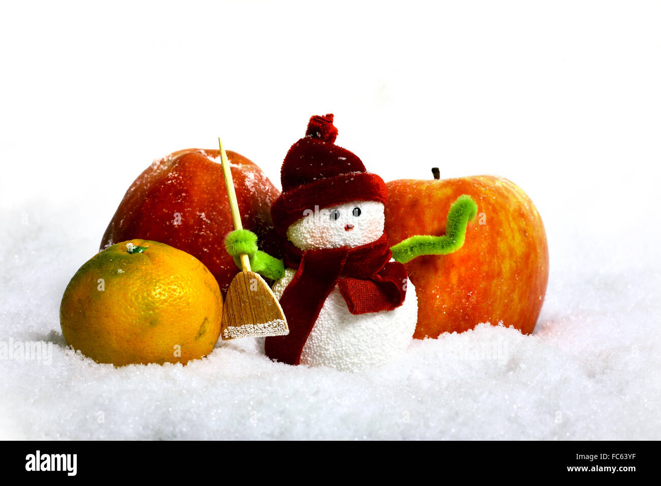 Snowman and apples in snow Stock Photo - Alamy