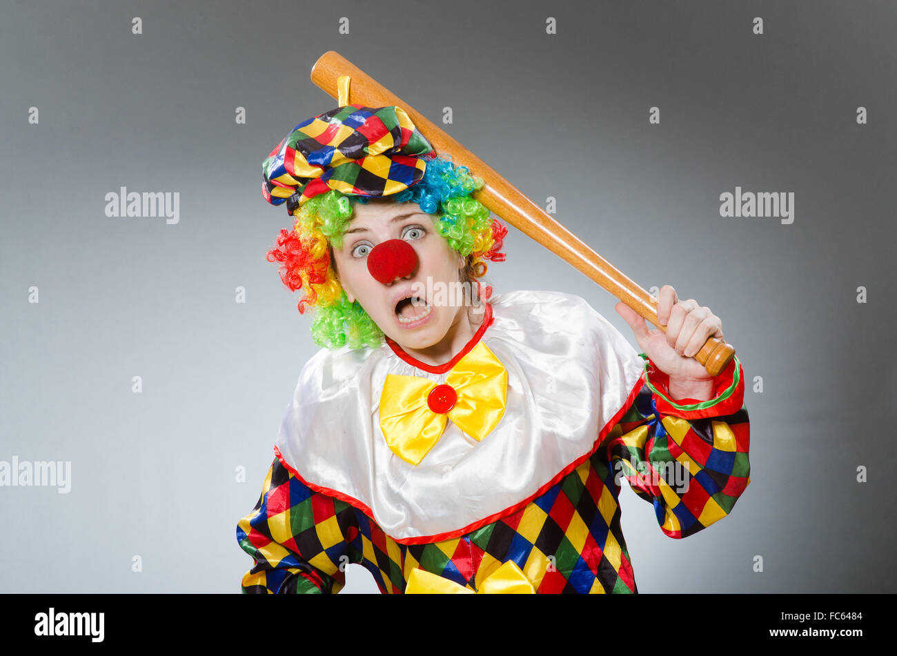 Clown with baseball bat in funny concept Stock Photo - Alamy