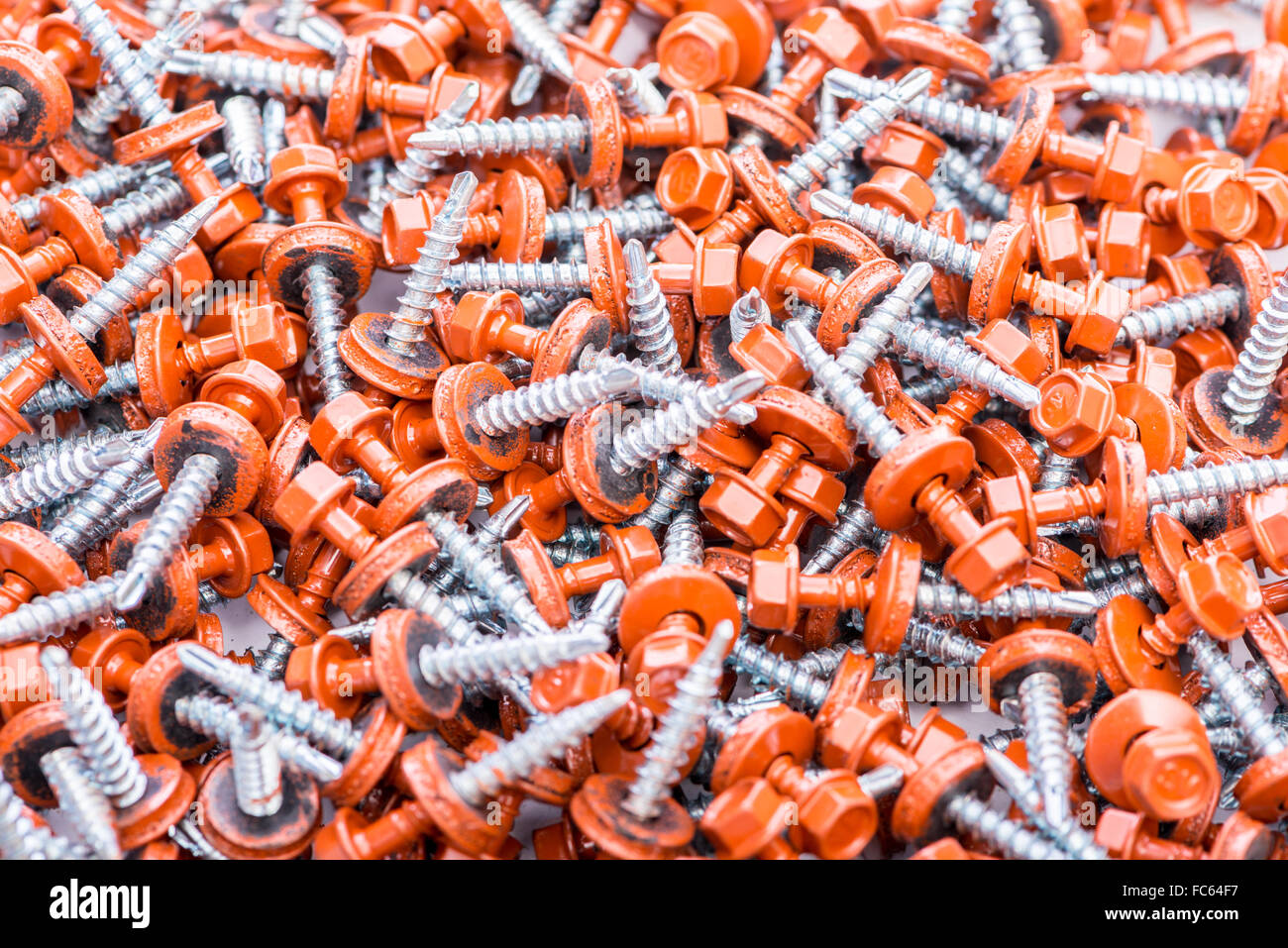 Many screws arranged as background Stock Photo - Alamy