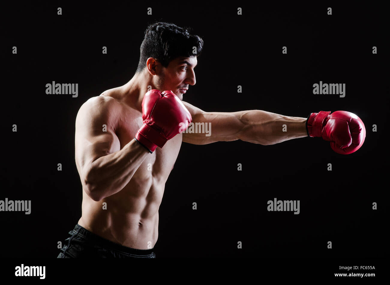 Muscular man in boxing concept Stock Photo - Alamy