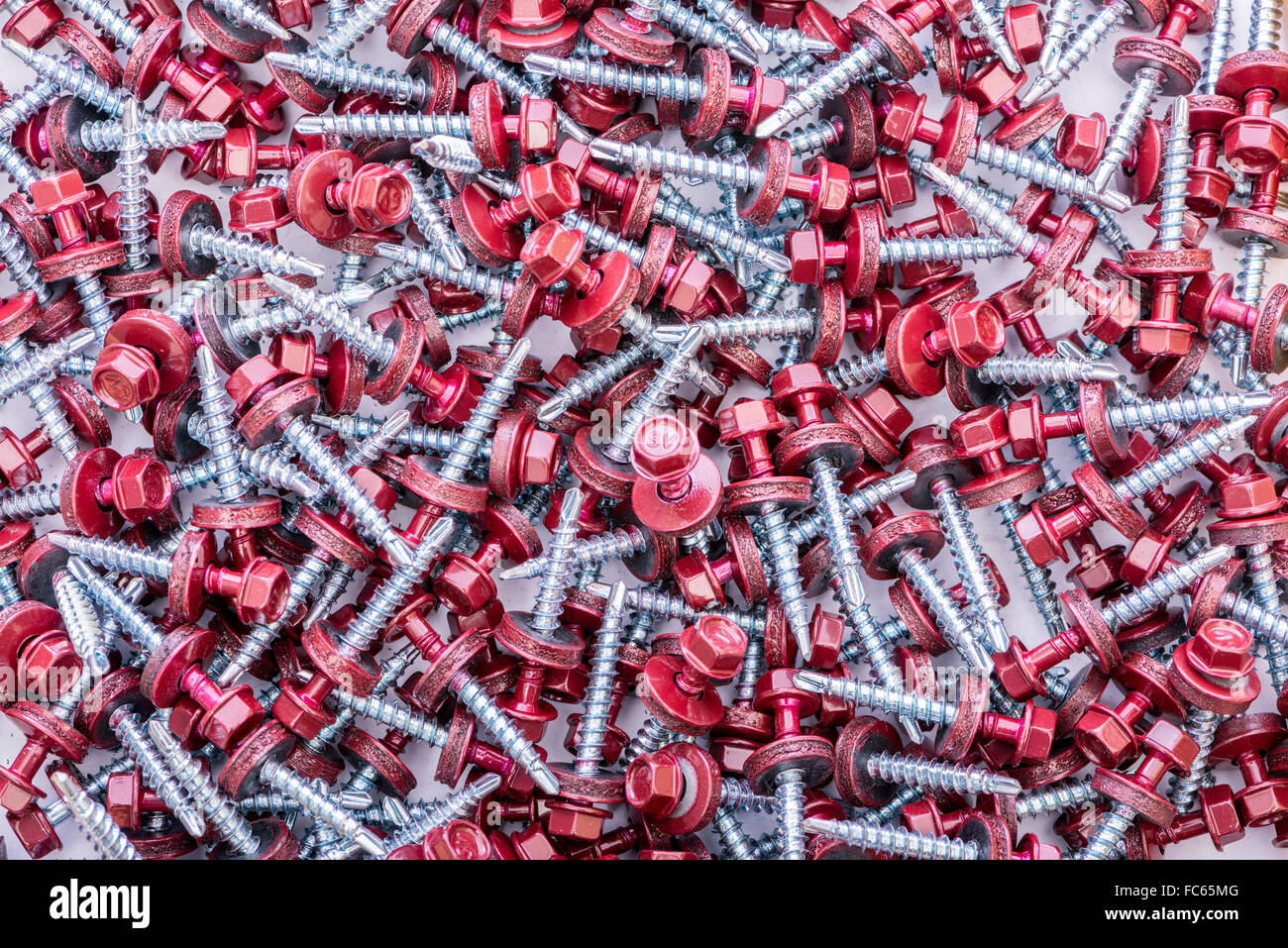 Many screws arranged as background Stock Photo - Alamy