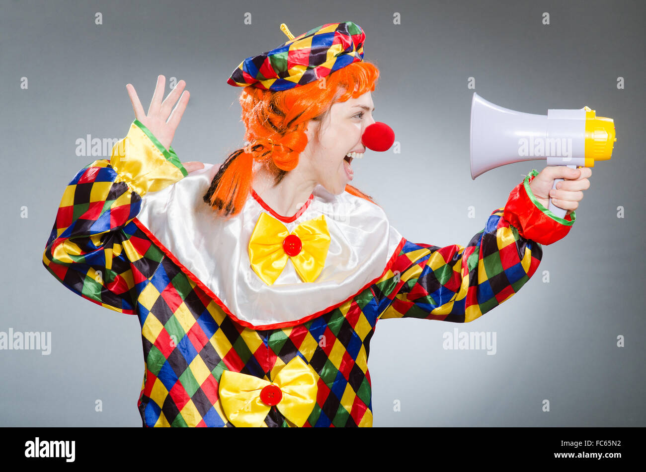 Clown with loudspeaker isolated on white Stock Photo - Alamy