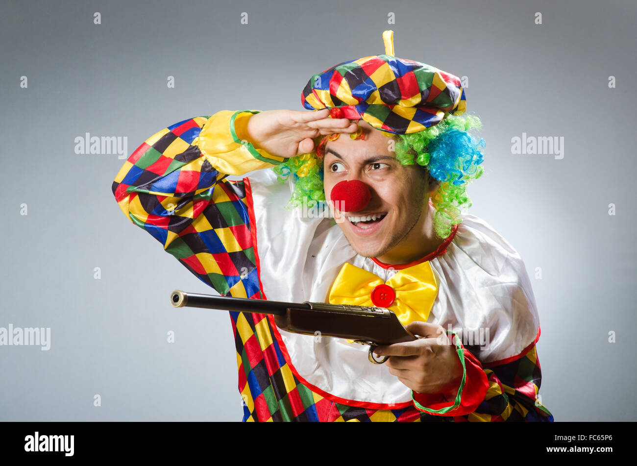 Clown with rifle isolated on white Stock Photo - Alamy