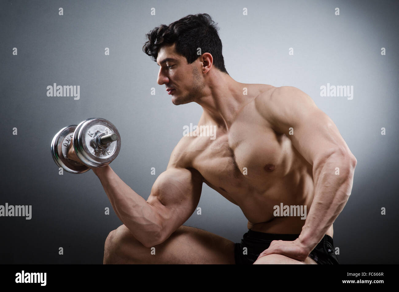 Muscular ripped bodybuilder with dumbbells Stock Photo - Alamy