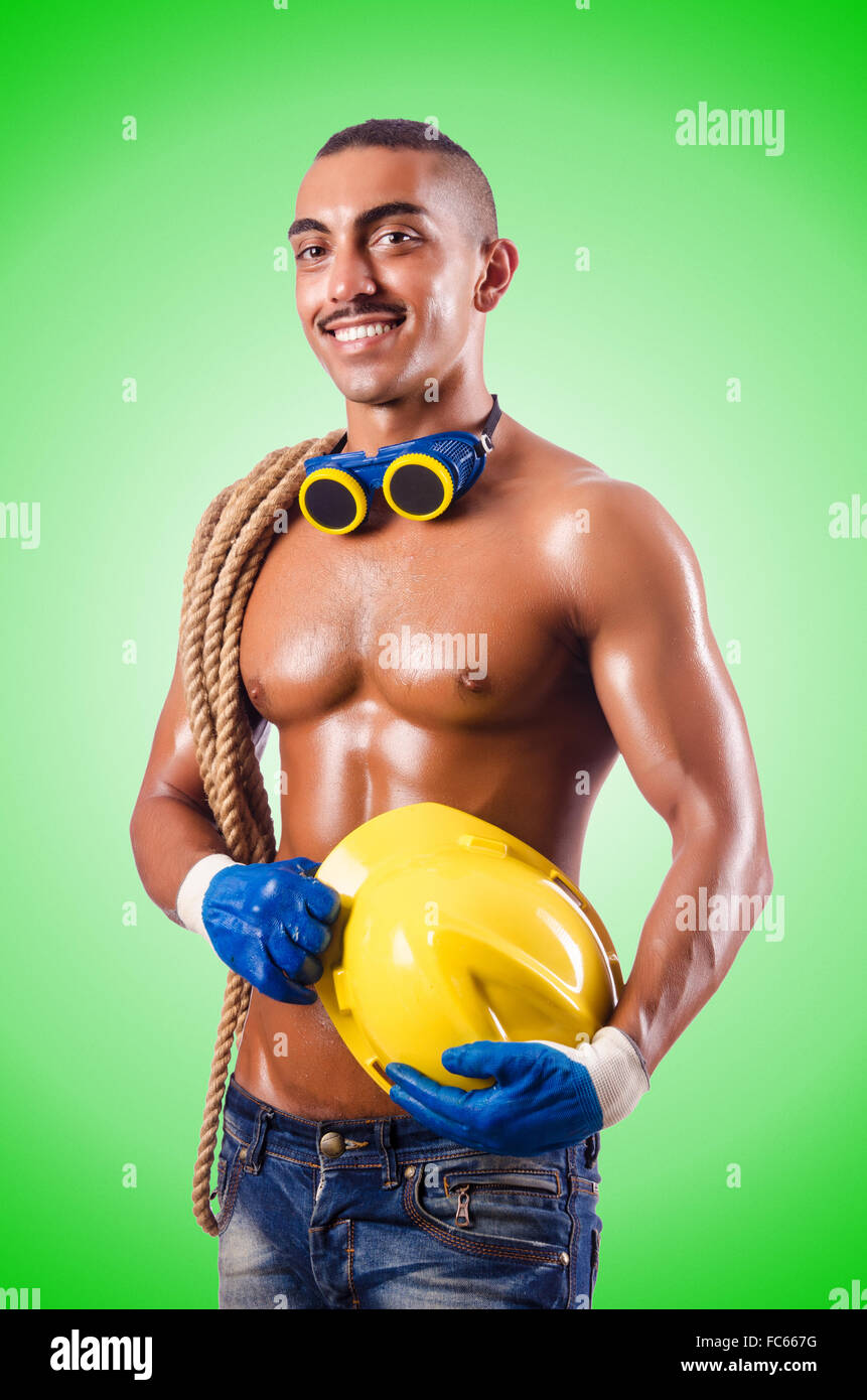 Muscular builder with tools isolated on white Stock Photo - Alamy
