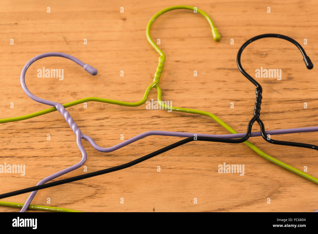 three colored hangers Stock Photo - Alamy