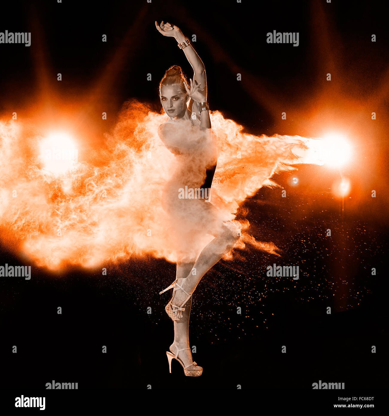 Young woman jumping in red powder cloud Stock Photo - Alamy