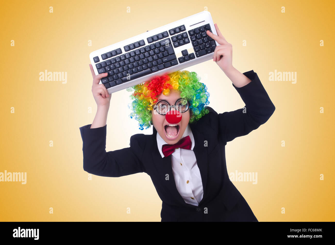 Funny clown with keyboard on white Stock Photo - Alamy